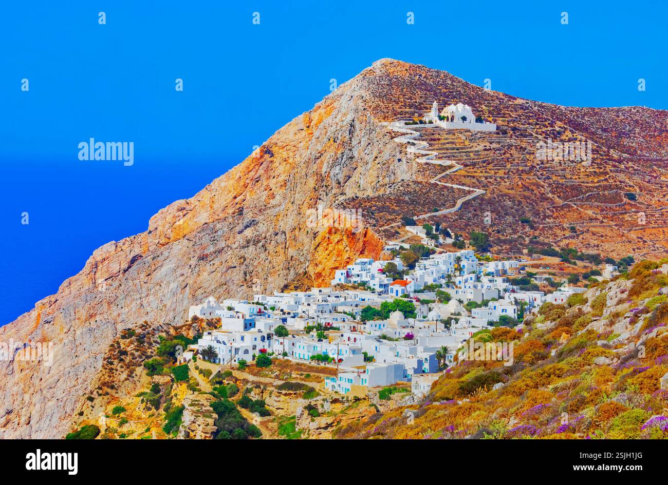 View of Chora village built on a cliff above the sea and Panagia ...
