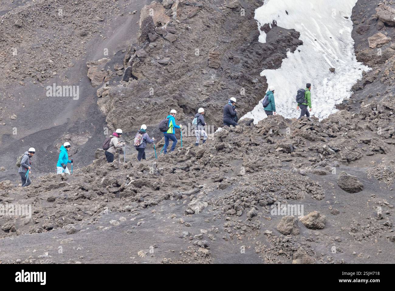 Group of hikers walking up to Mount Etna summit, Etna, Sicily, Italy ...