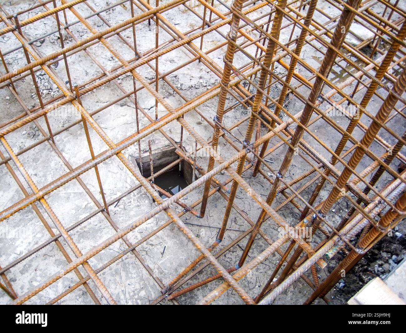 Close-up of a rebar structure lying on the ground, ready to be encased ...