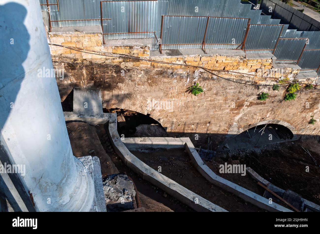 A high-angle shot shows the architectural remains of an old building ...