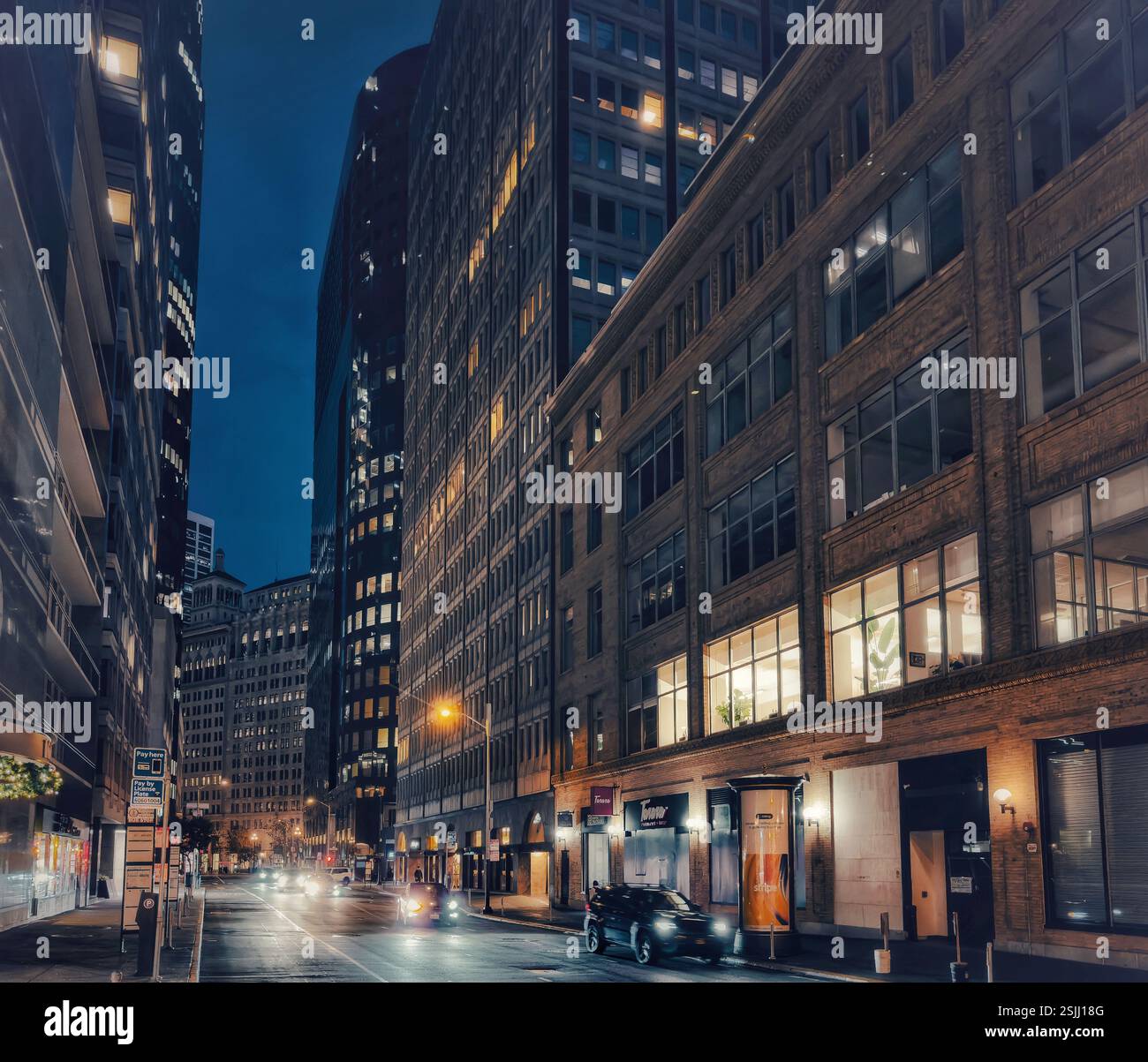 The image captures a bustling San Francisco street at night ...