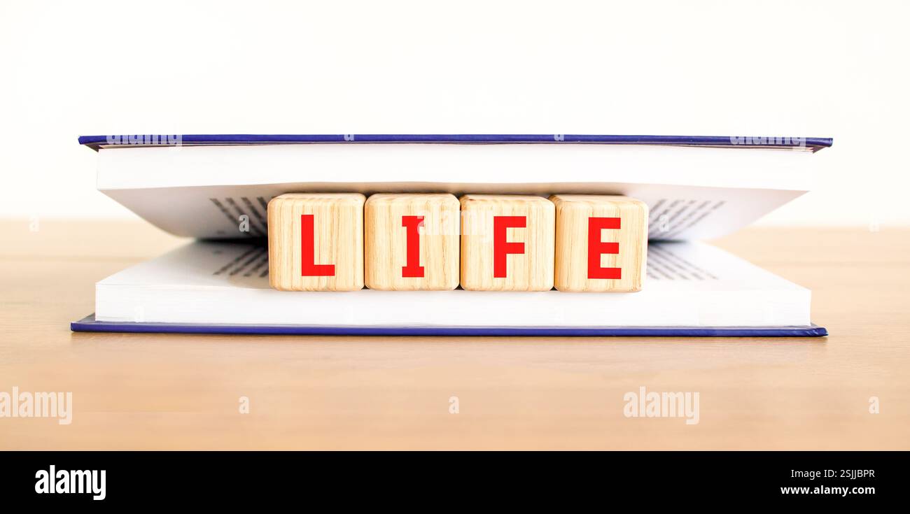 Life symbol. Concept word Life on beautiful wooden blocks in book ...