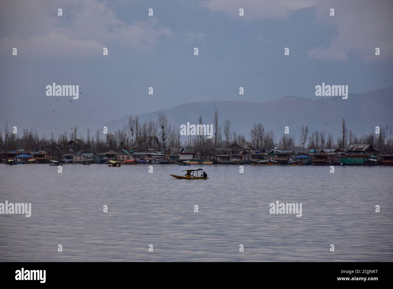 A boatman rows his boat across the world famous Dal lake in Srinagar, the summer capital of ...