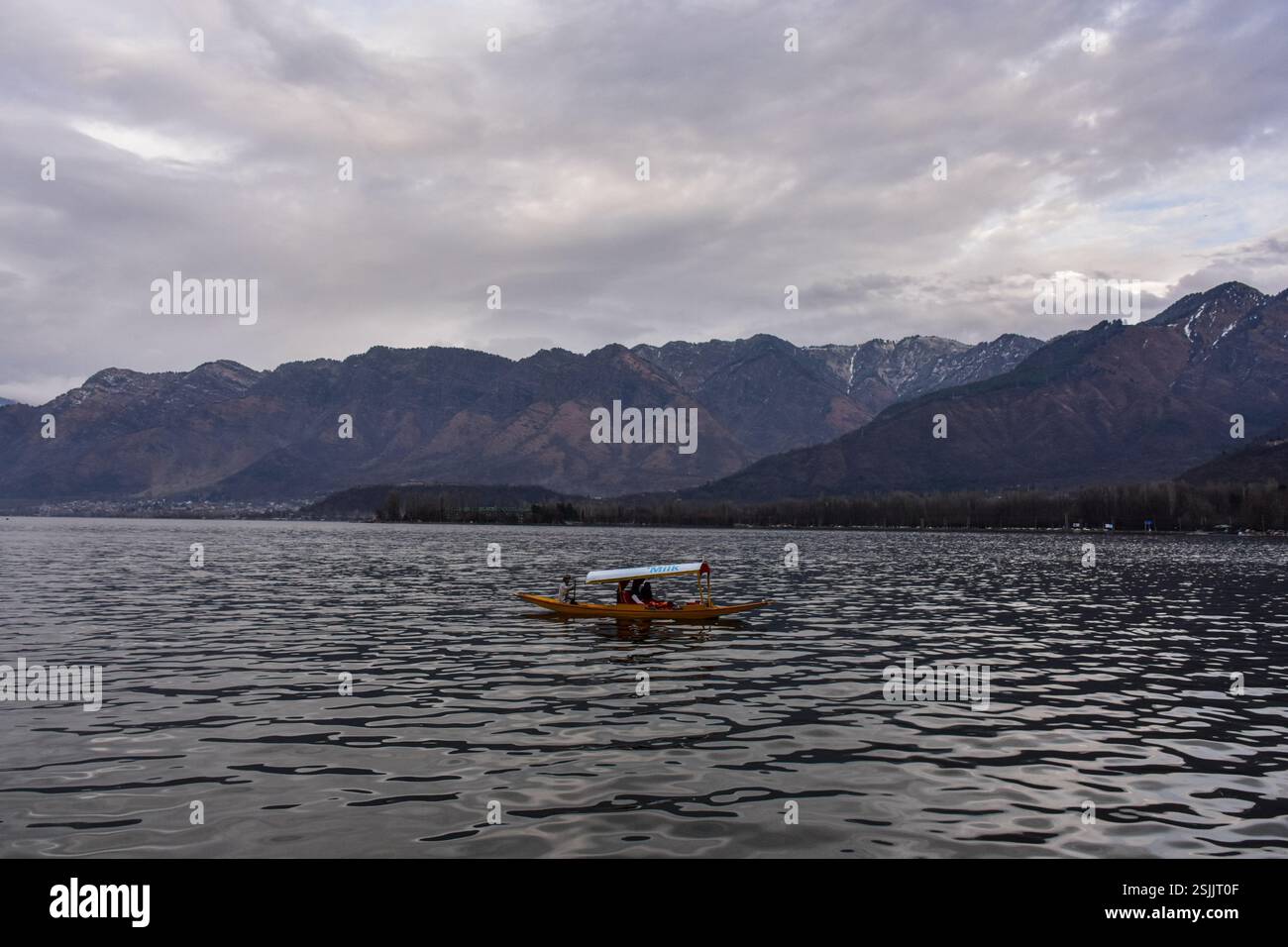 A boatman ferries tourists in his boat across the world famous Dal lake in Srinagar, the summer ...