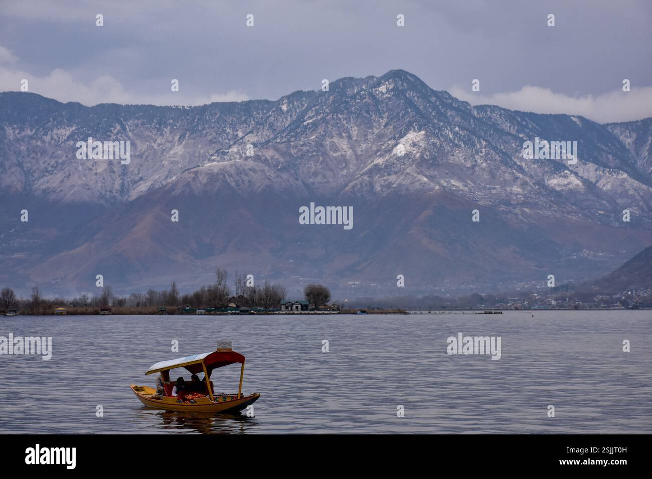 A boatman ferries tourists in his boat across the world famous Dal lake in Srinagar, the summer ...
