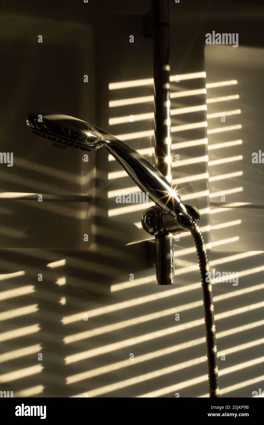 A photo of a modern shower, illuminated by dramatic contrast light ...