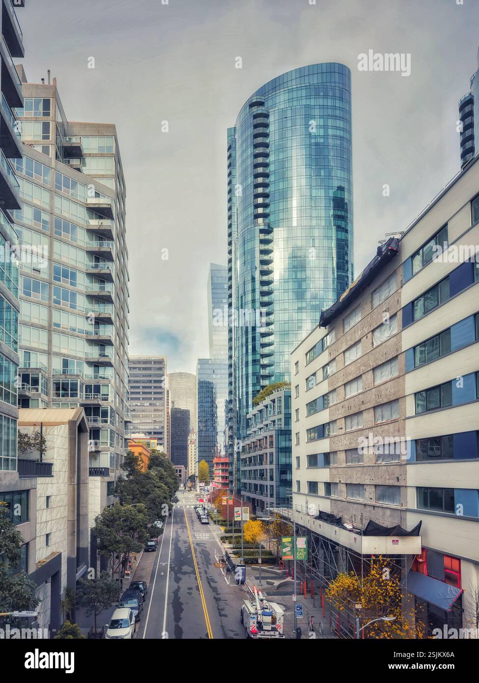 The image captures a street lined with tall buildings and autumnal ...