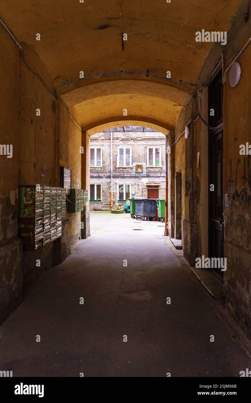 Entrance through the gate to the courtyard of a historic tenement house ...
