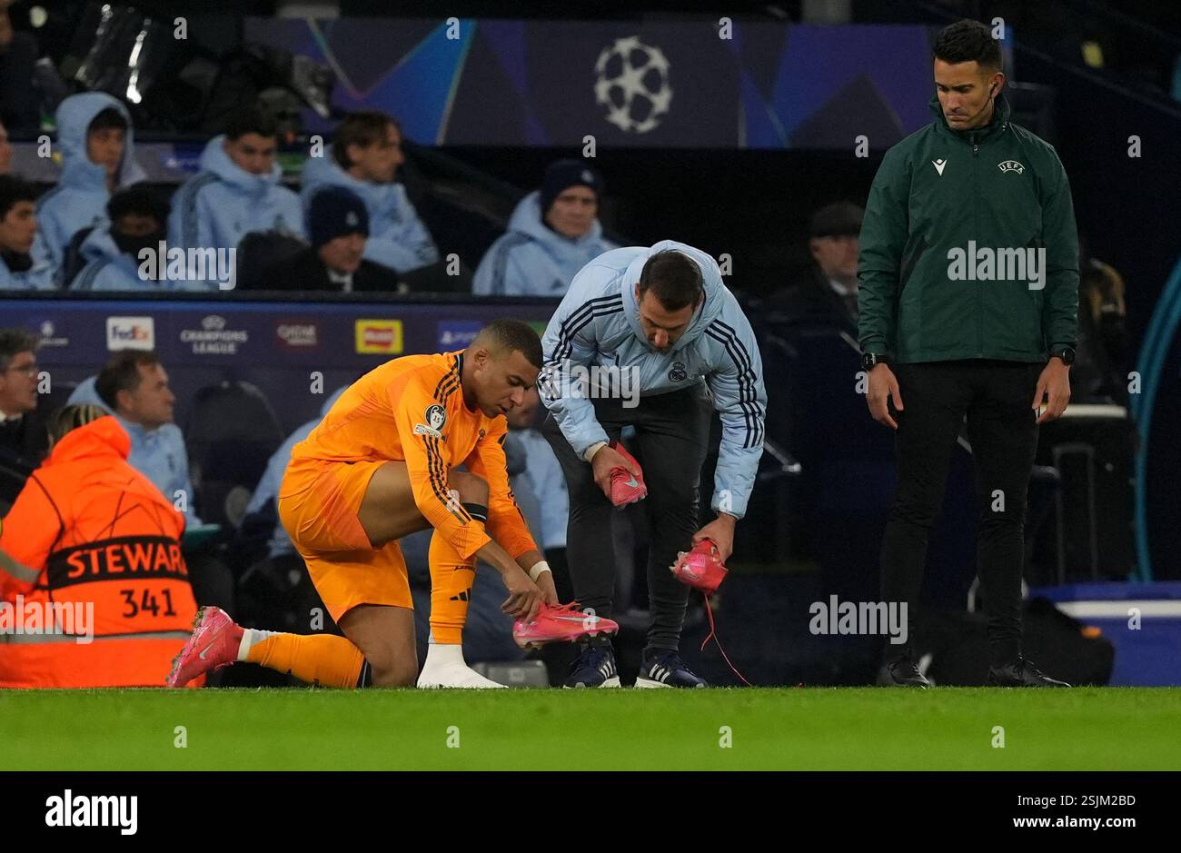 Real Madrid's Kylian Mbappe changes his boots during the UEFA Champions ...