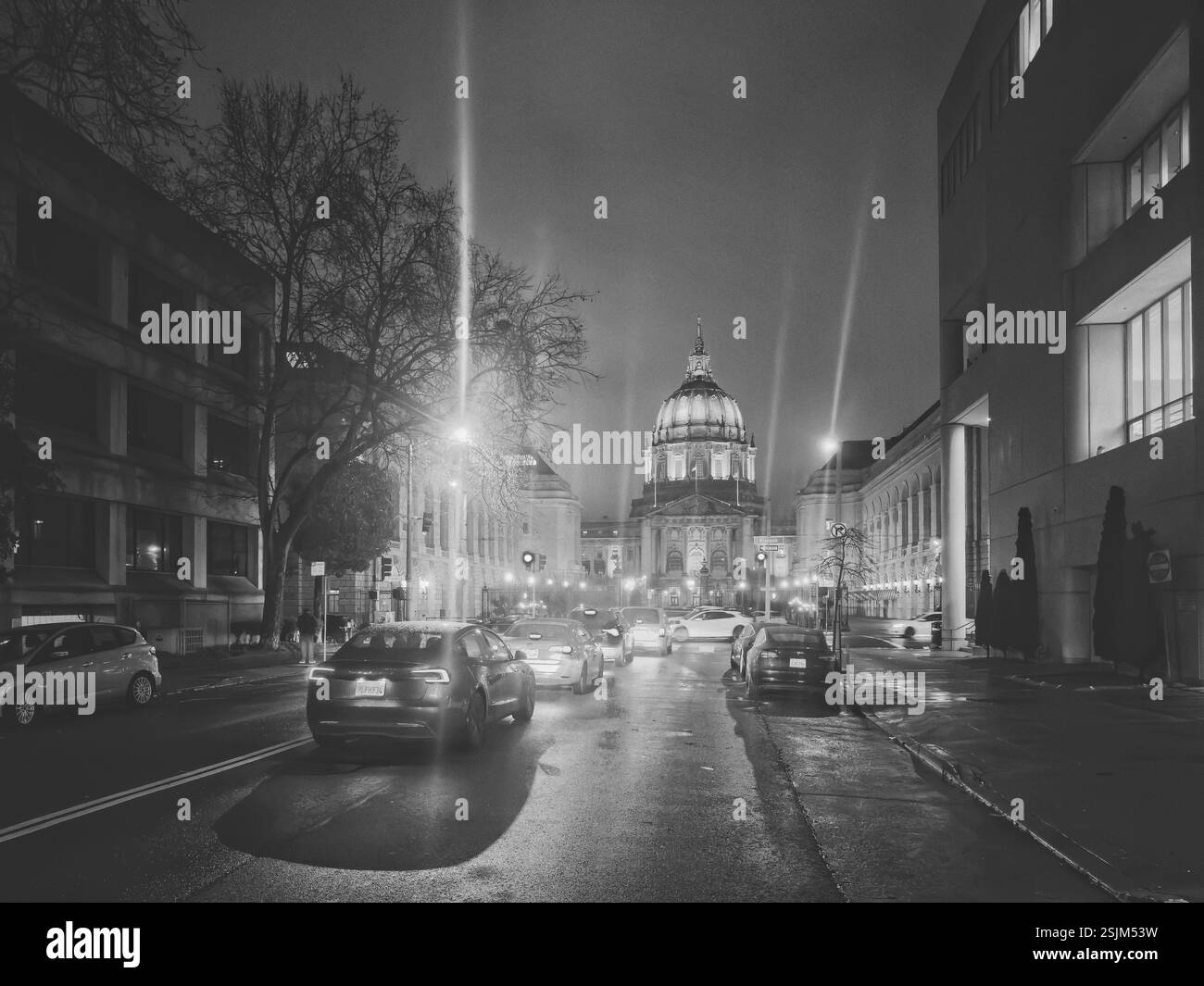 A black and white photograph captures San Francisco City Hall at night ...