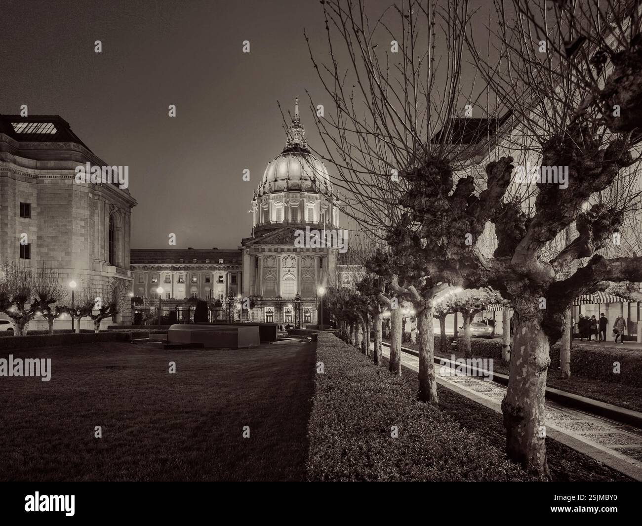 A black and white photograph captures San Francisco City Hall at night ...