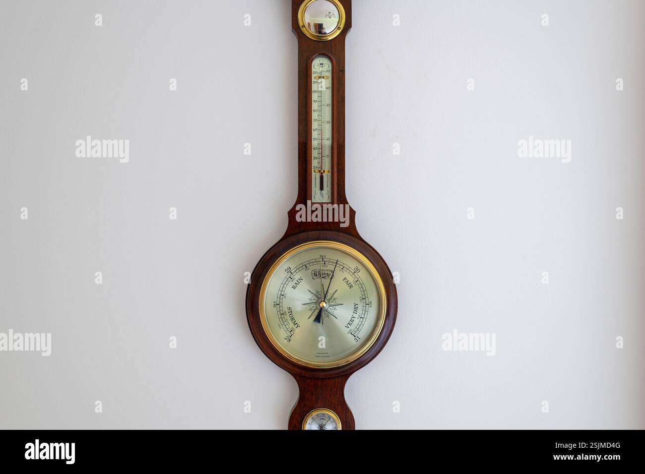 Close up of an aneroid barometer mounted on a wall Stock Photo - Alamy