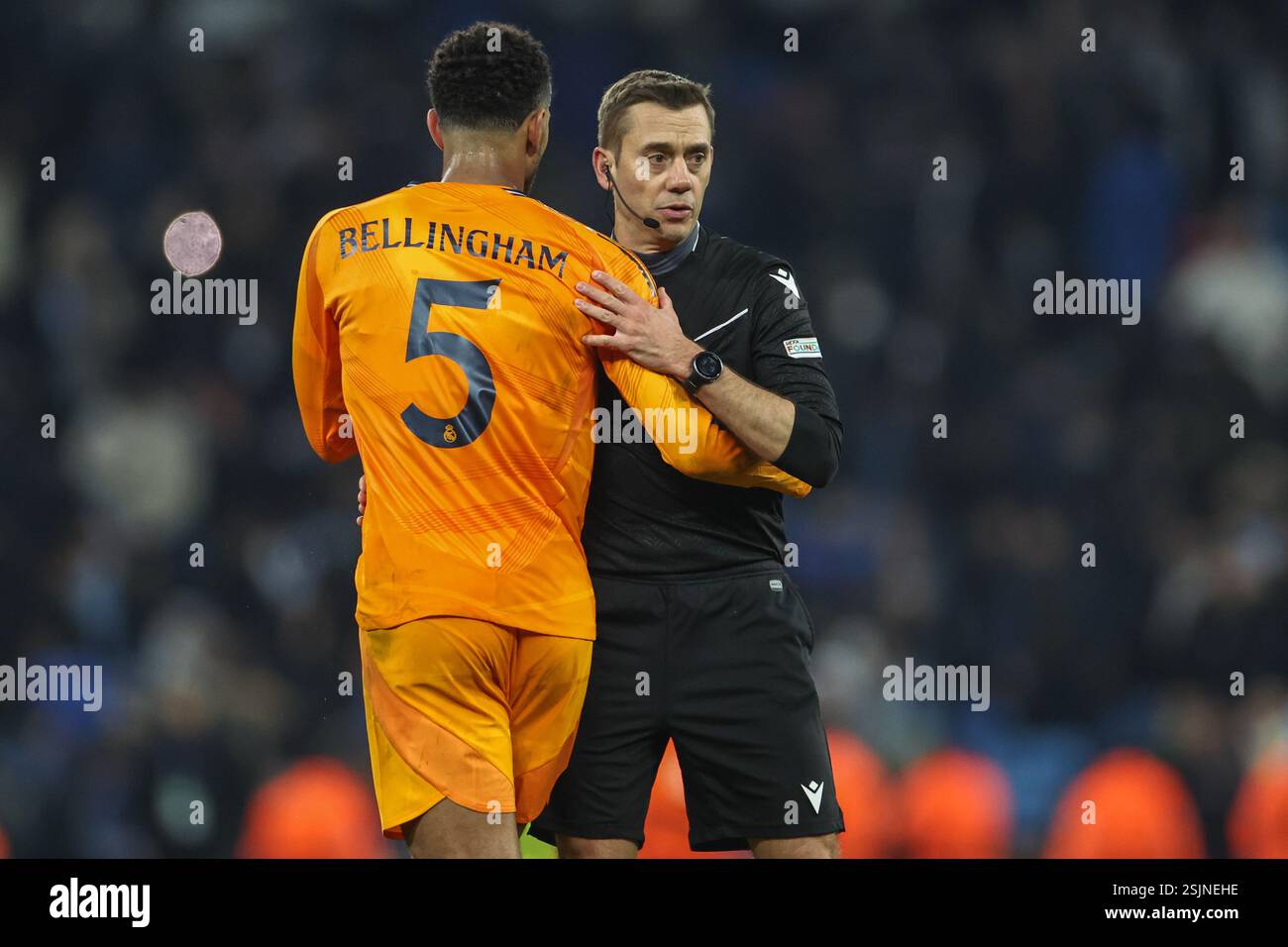 Referee Clement Turpin embraces Jude Bellingham of Real Madrid after he ...