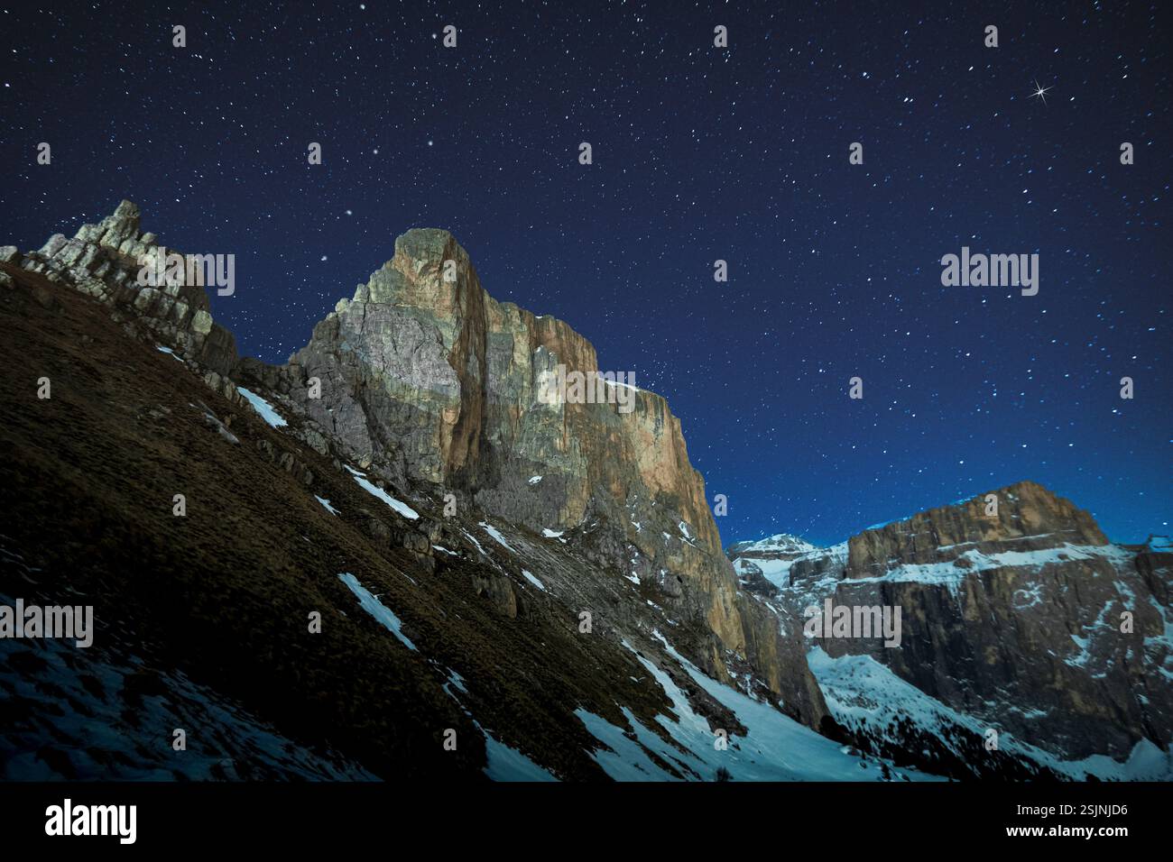Dolomites Sella towers under a starry night during winter Stock Photo ...