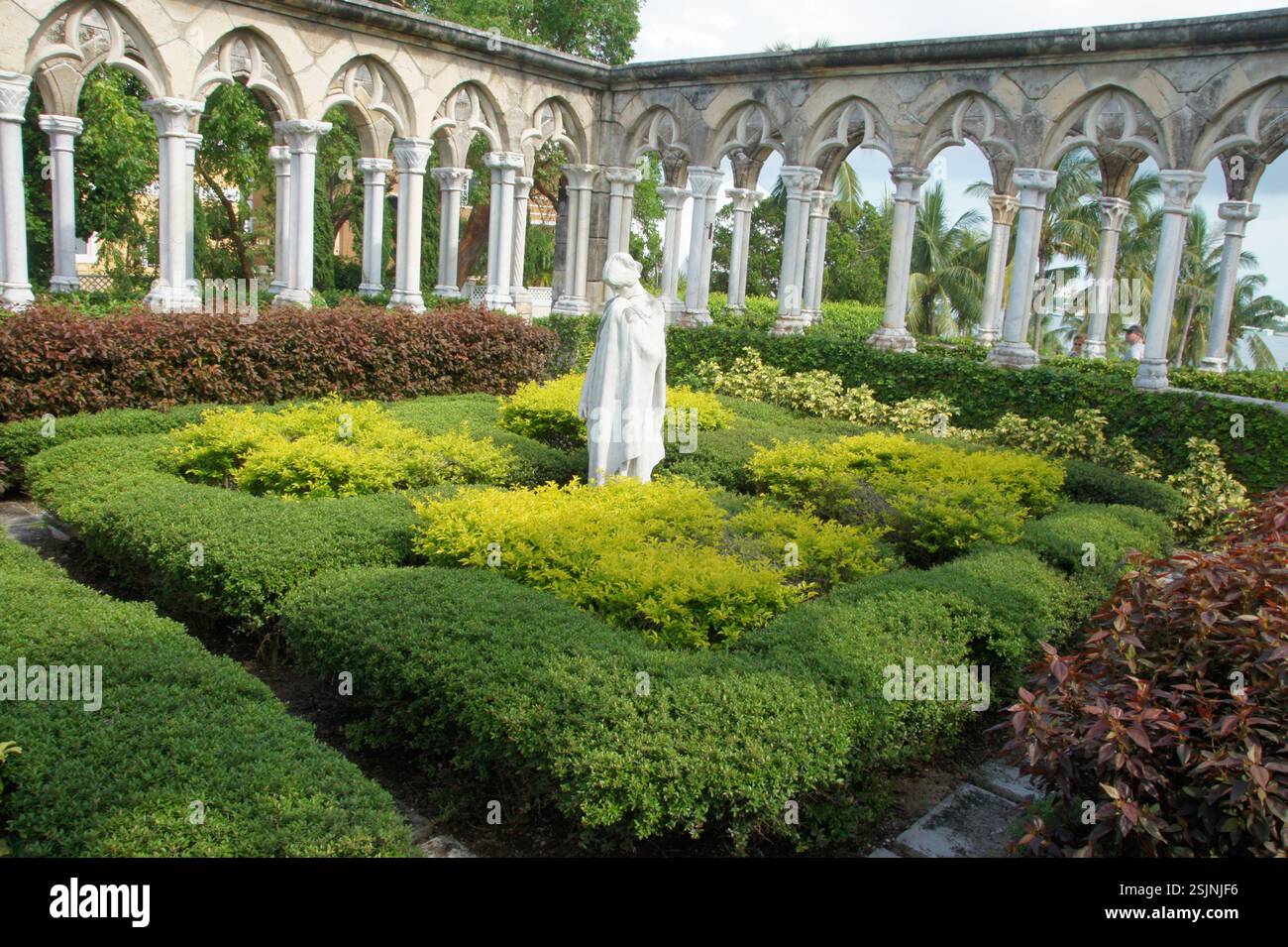 Architectural Garden. Symmetrical hedges frame a white statue amidst ...