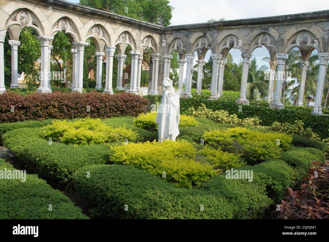 garden in the Bahamas features symmetrical hedges framing a white ...