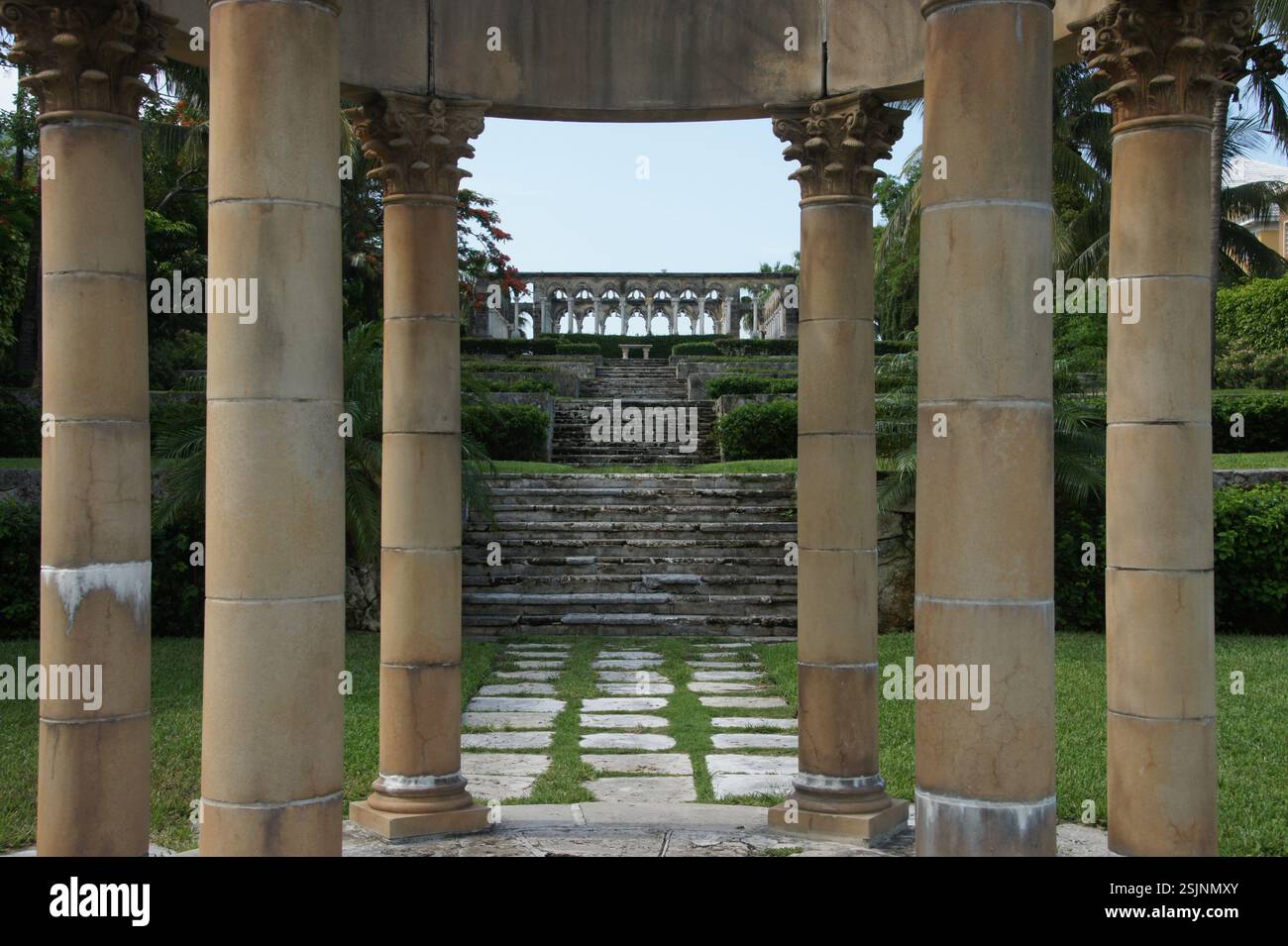 Cloisters, stone columns frame walkway lined with hedges. Gothic ...