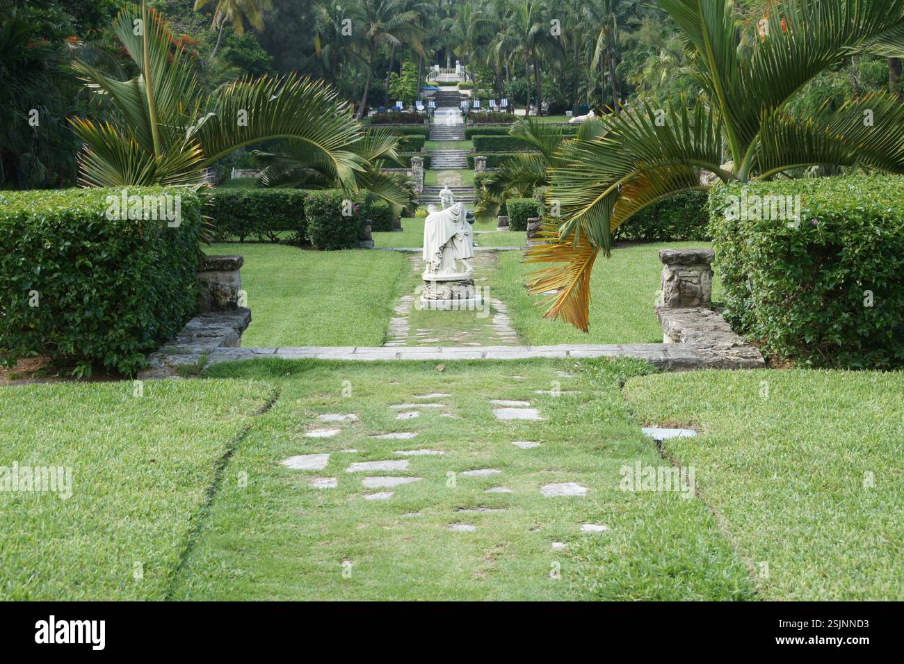 Formal garden, manicured hedges, stone pathway, sculptures. Symmetrical ...