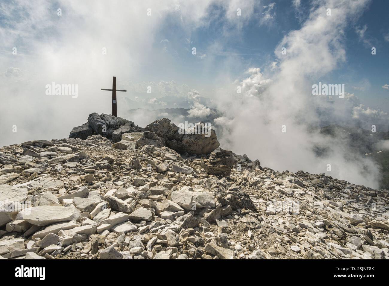 Summit cross on alpine peak surrounded by clouds Stock Photo - Alamy