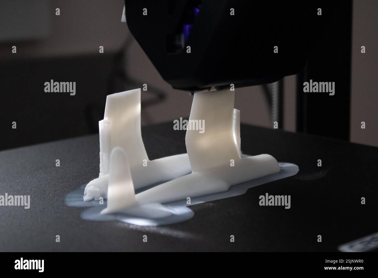 An object taking shape with a 3D printer, demonstrating the potential ...