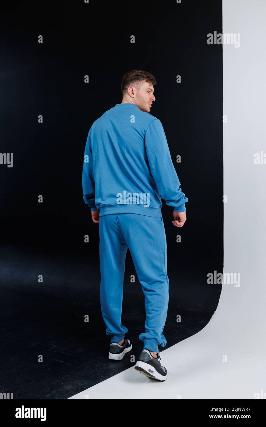 A stylish and fashionable male model dressed in blue activewear ...
