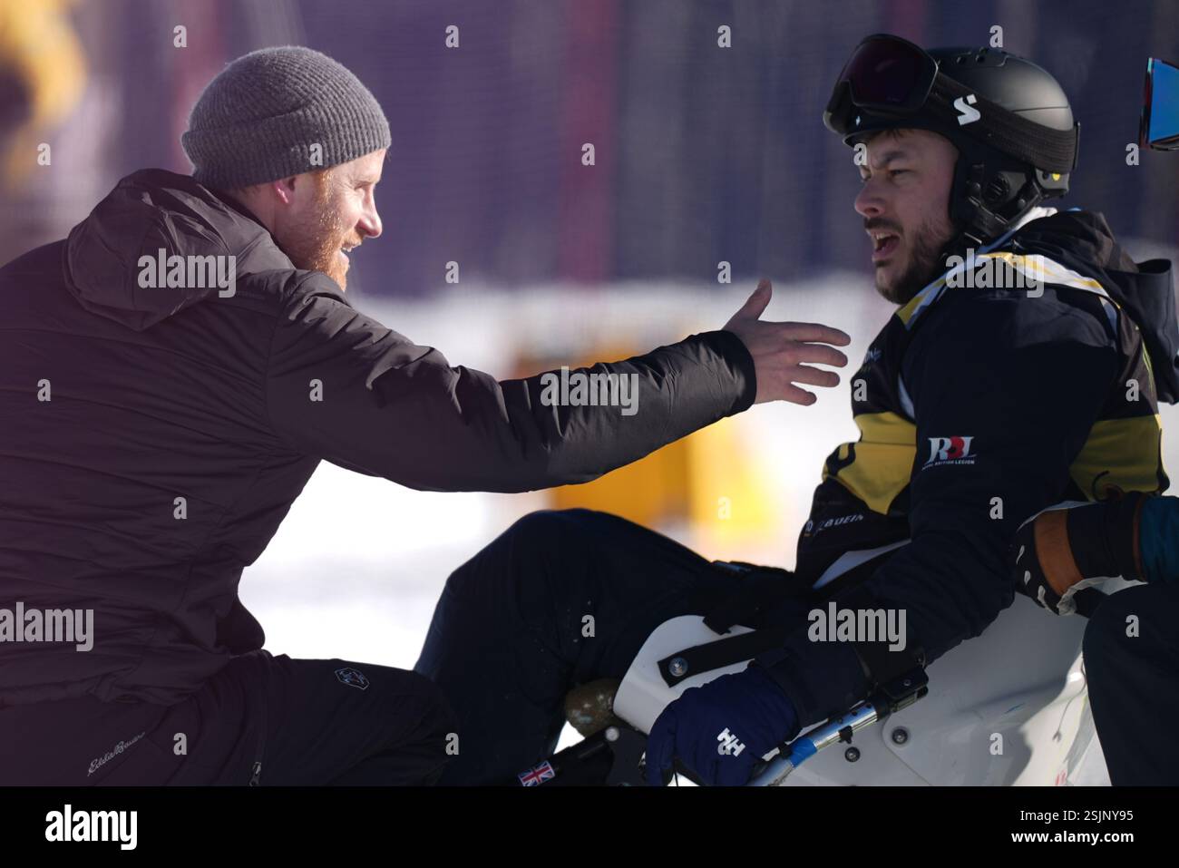 The Duke of Sussex speaks with a competitor at the Alpine Skiing and ...