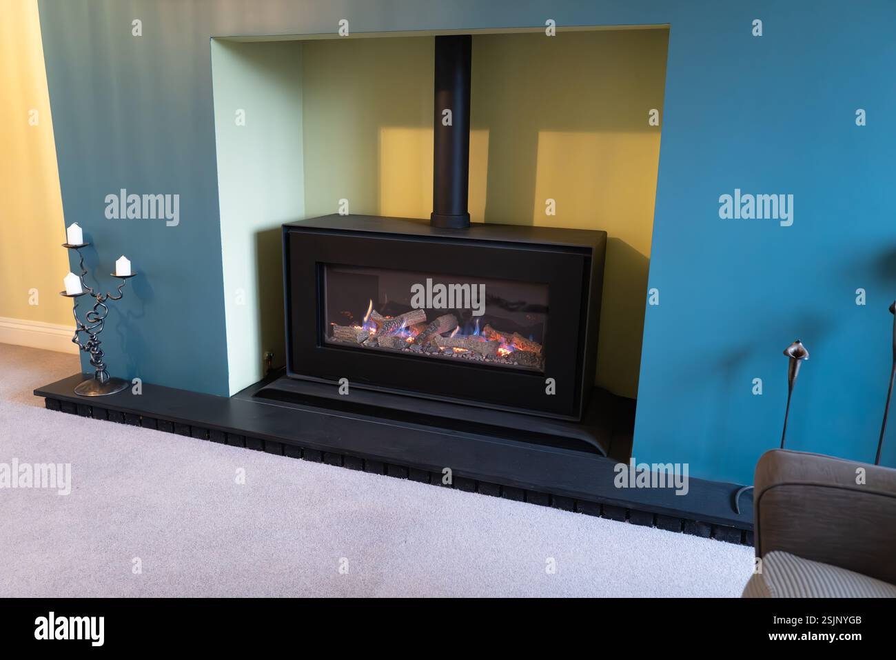Large modern, stove like, gas fire with a log effect, in a modern ...