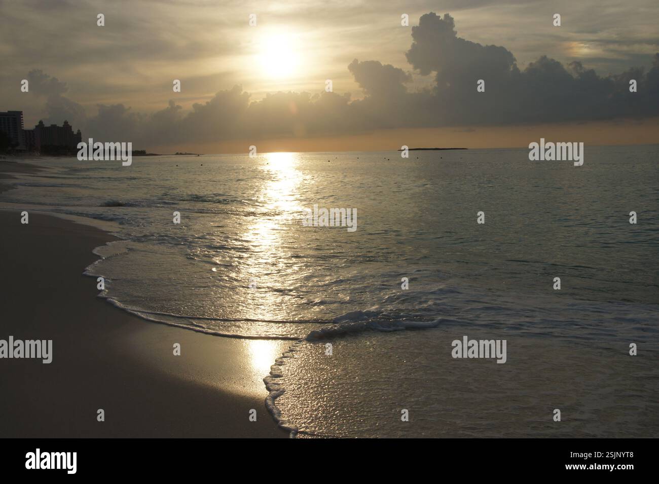 Beach Sunset Bahamas. Golden light reflects on calm waves as the sun ...