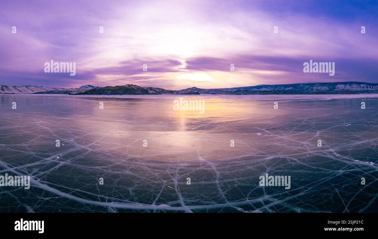 Aerial view on transparent frozen water, violet sunset in background ...