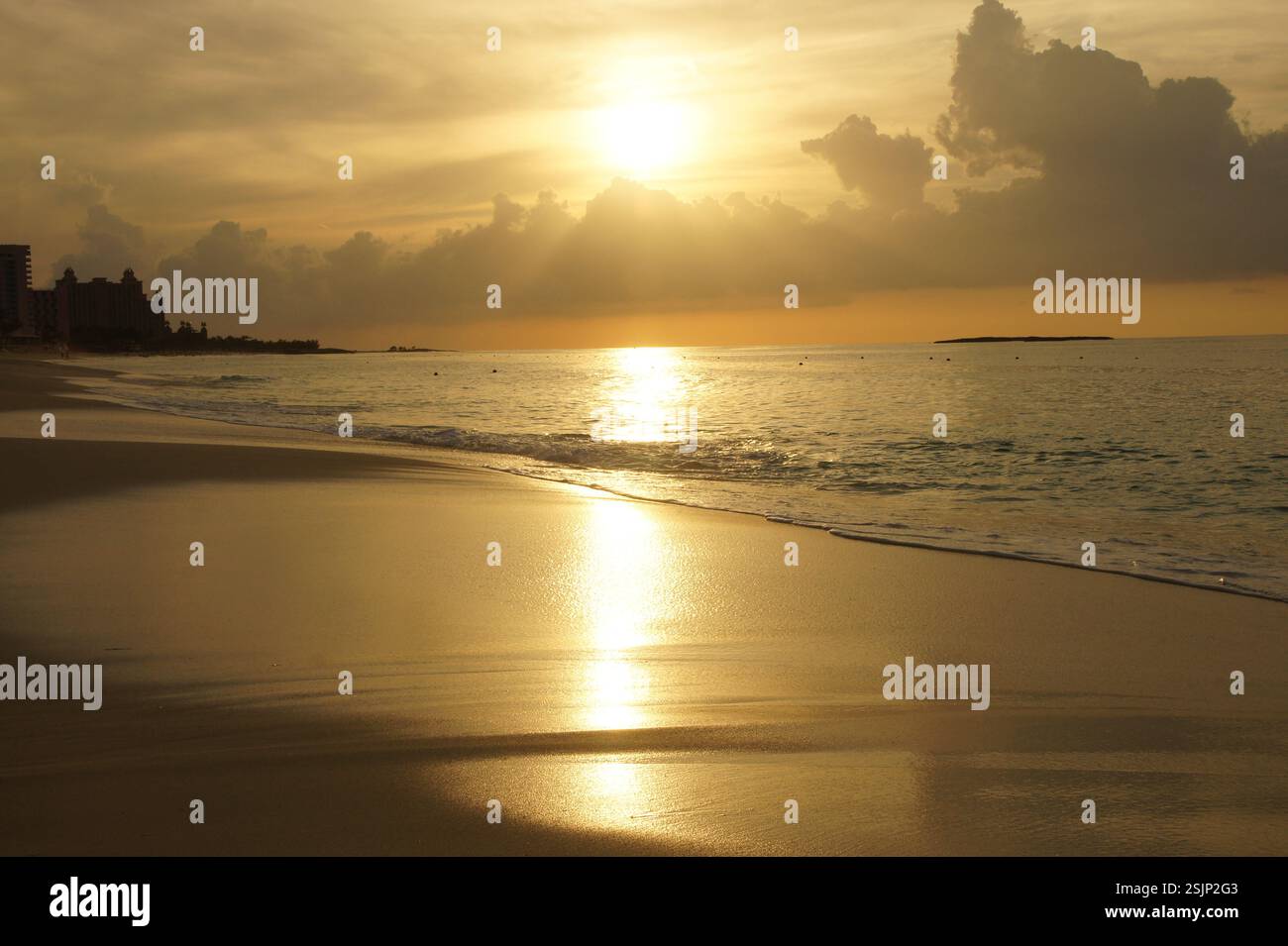 Beach sunset in the Bahamas. Golden sky reflects on the sand. Warm ...