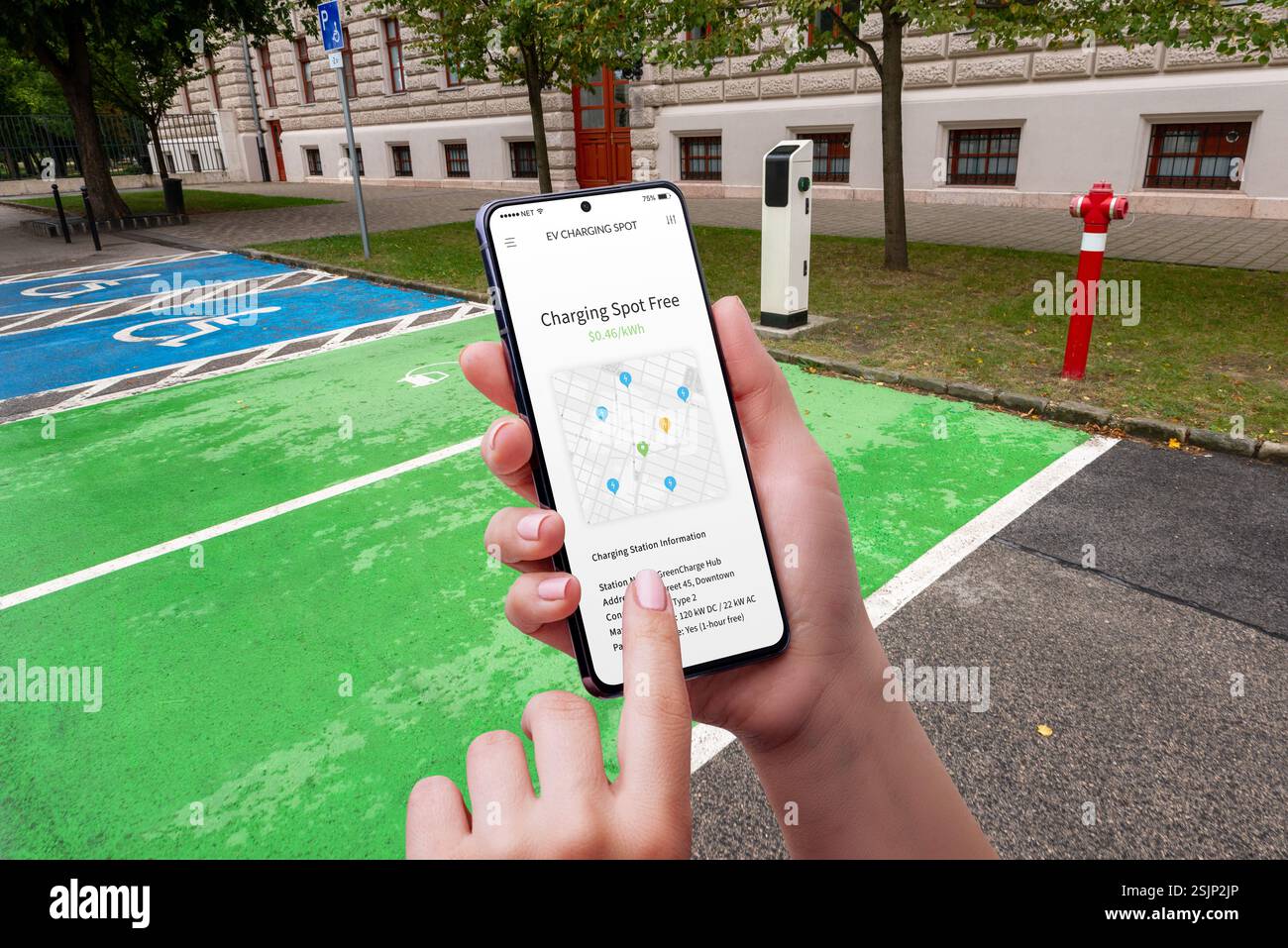User stands in an EV charging station parking lot, holding a smartphone ...