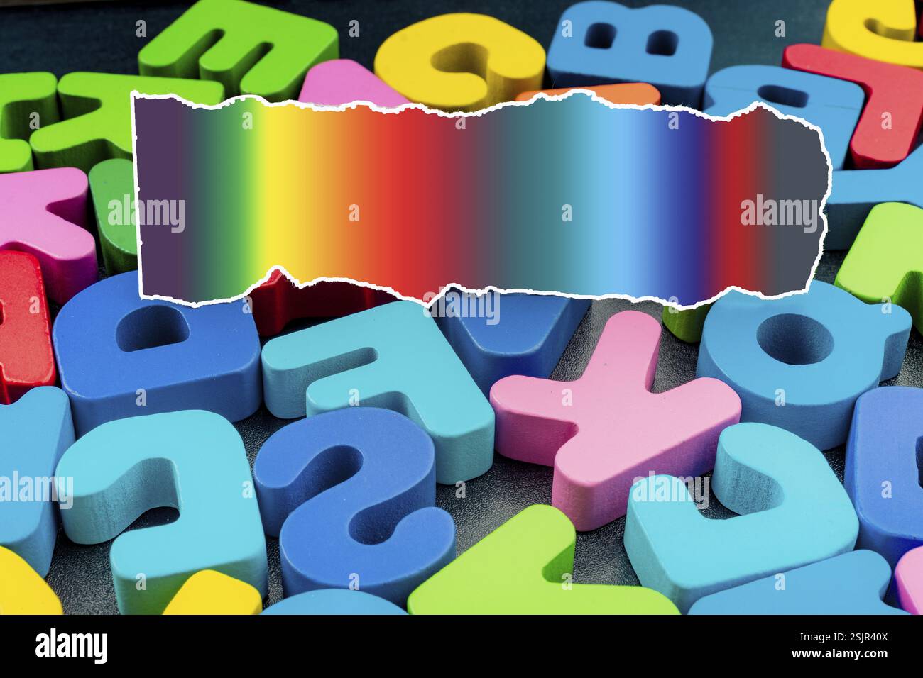 Torn paper placed on Colorful Letters of Alphabet Stock Photo - Alamy