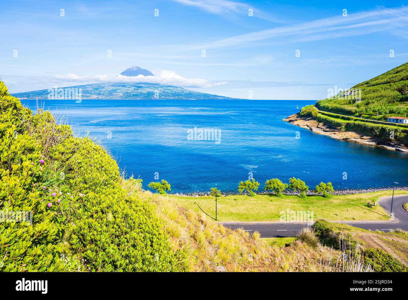 View of Pico volcano from Faial island with rocks and blue ocean in ...