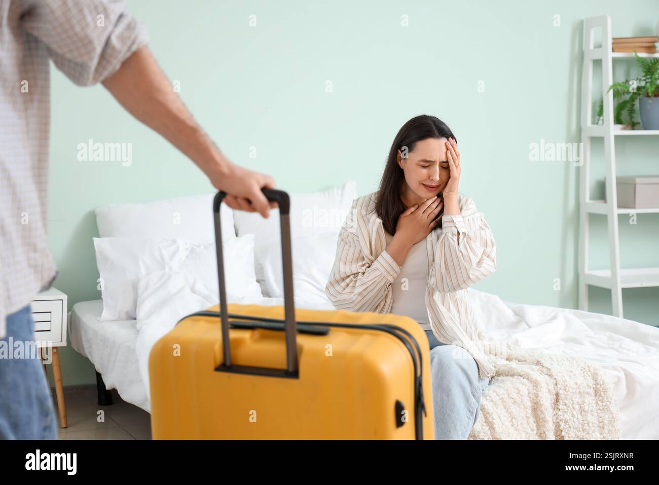 Crying young woman with her husband leaving in bedroom. Cheating ...