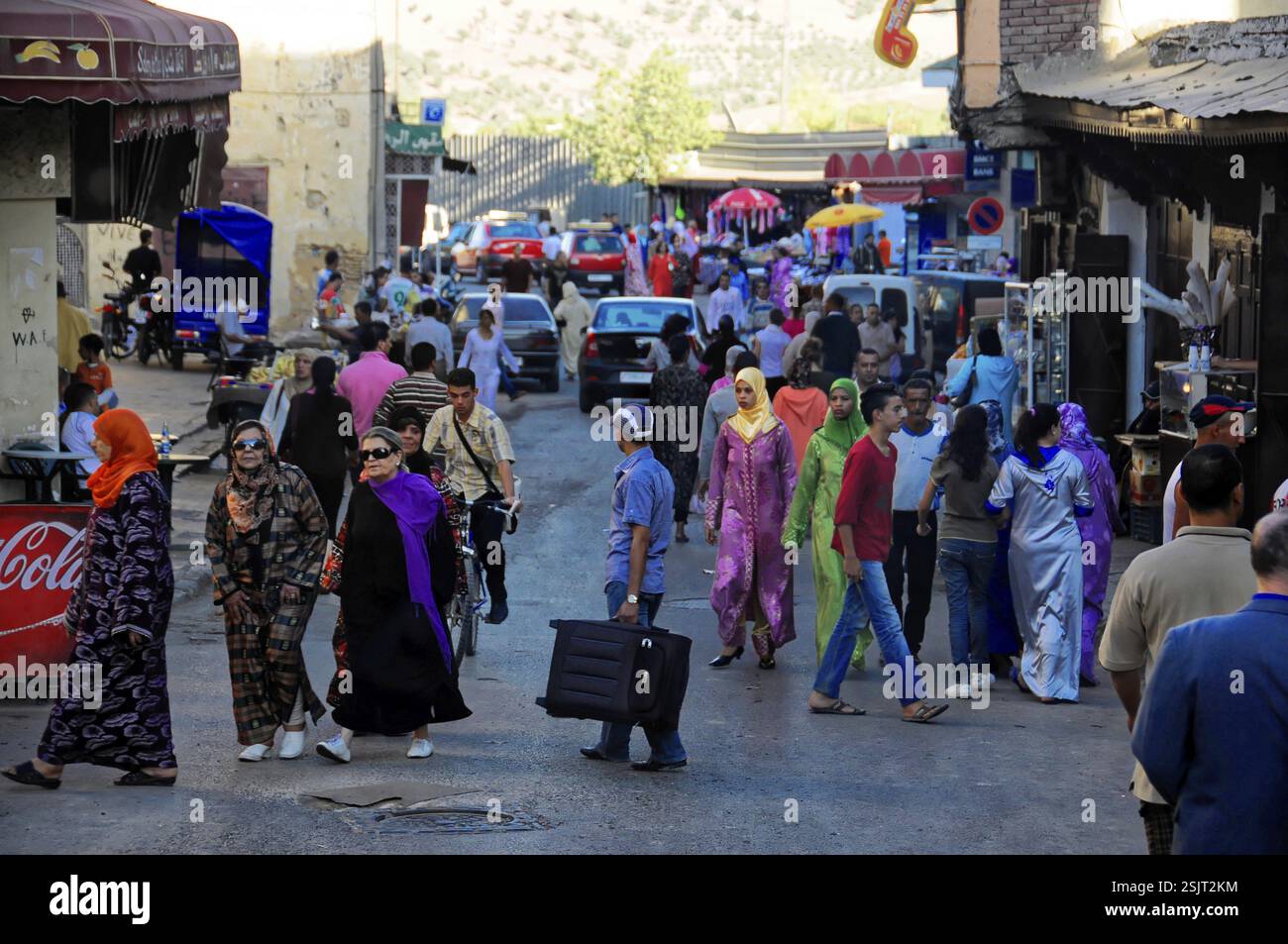 Fes, Northern Morocco, Morocco, People in traditional dress walk ...