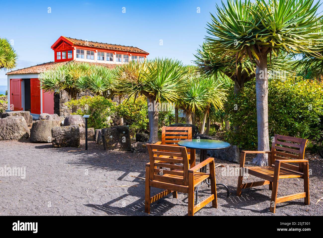 Chairs with table and historic traditional buildings in vineyard ...