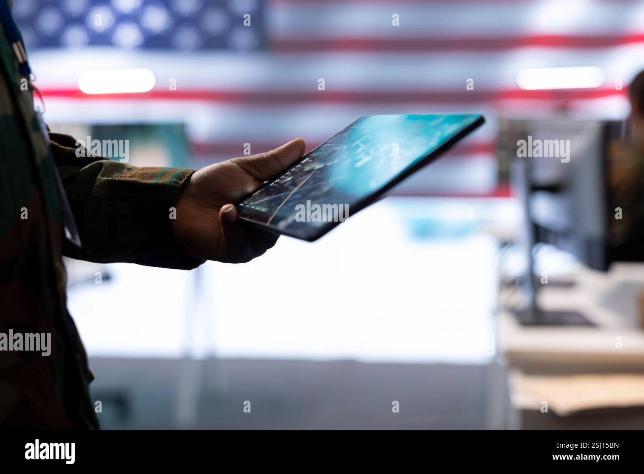 Professionals in US military uniforms operate computers and big screen ...