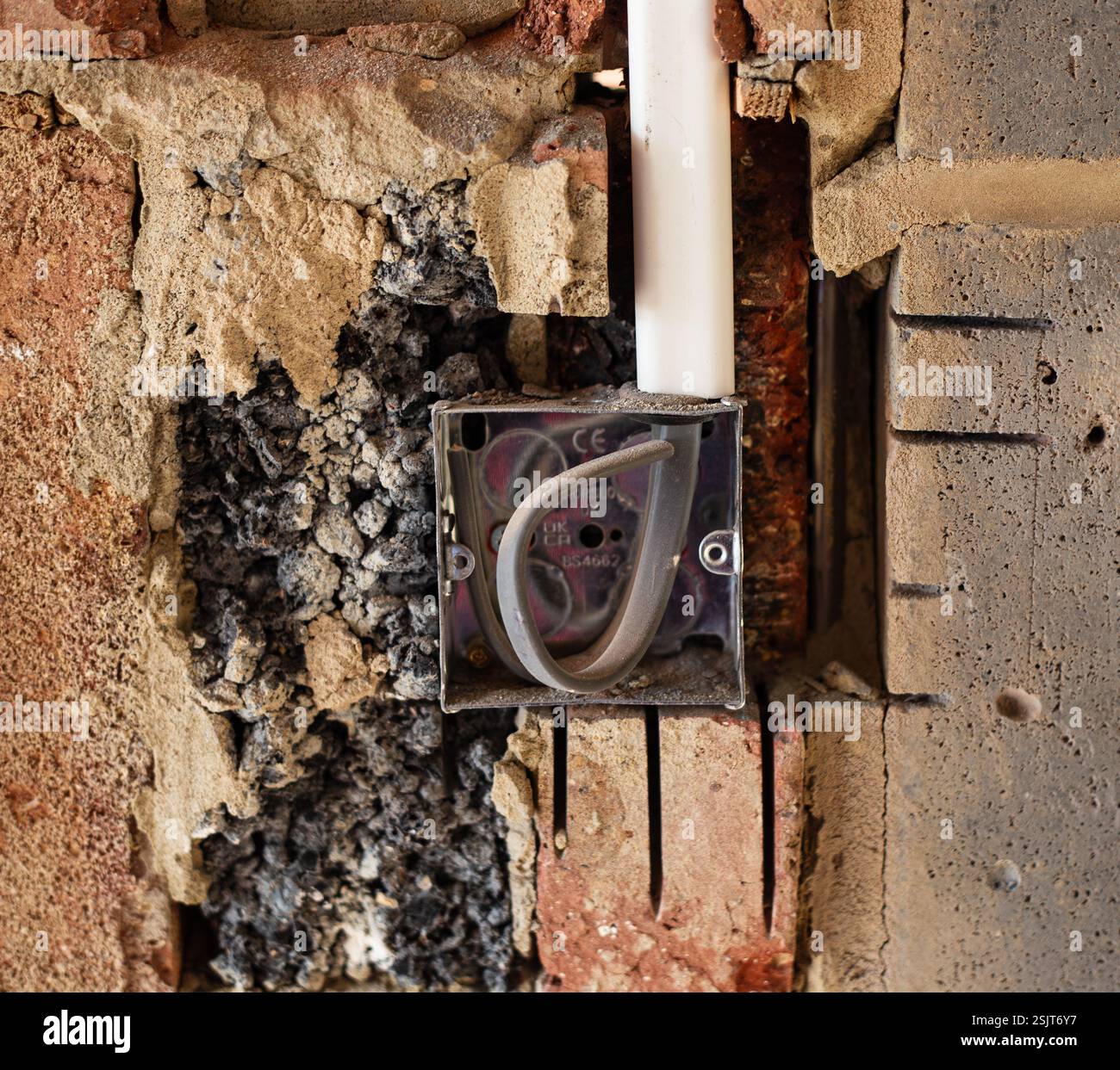 Brick wall cut out for single electric socket Stock Photo - Alamy