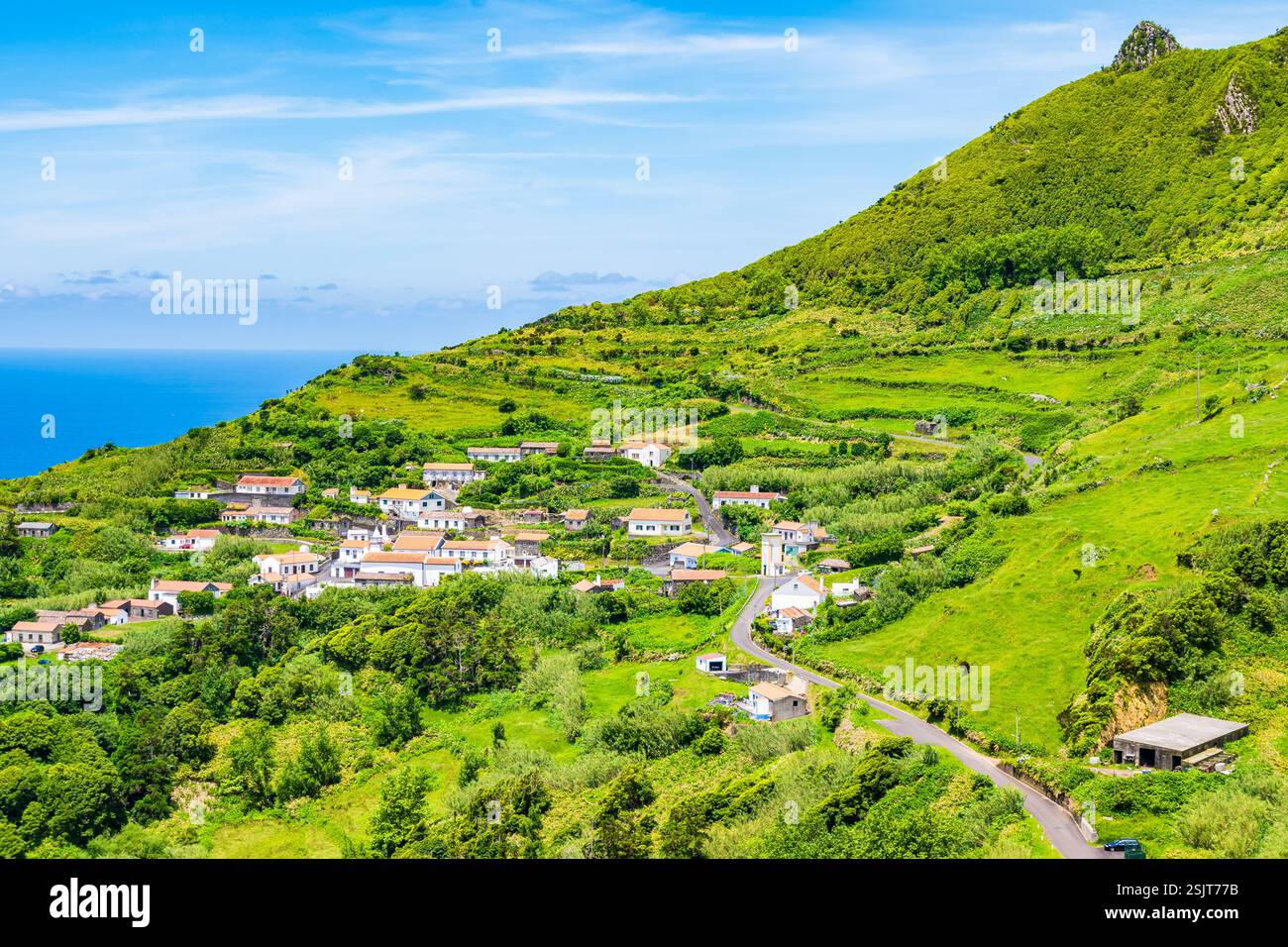 View of small Lajedo village among mountains and green hills, Flores ...