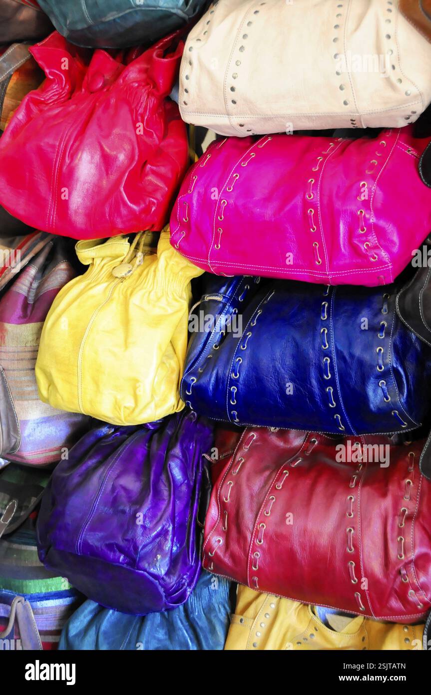 Colourful leather handbags, artfully arranged at a market, Fes ...