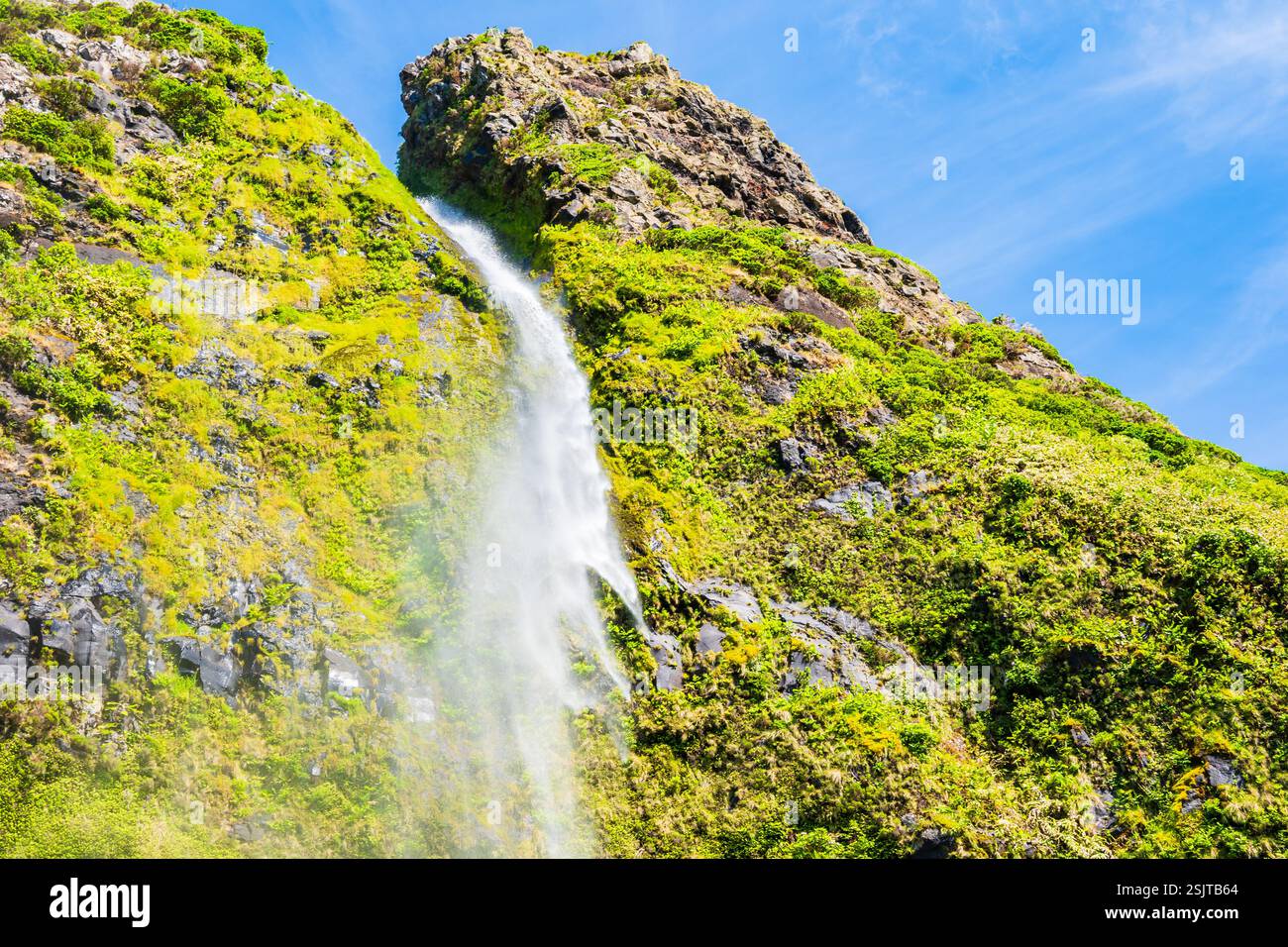 Water falling from large height waterfall of Poco do Bacalhau and green ...