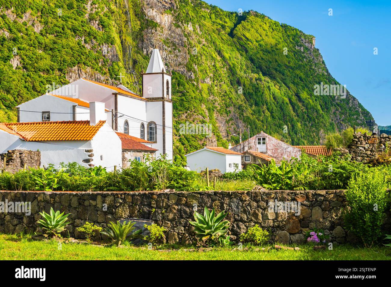 Church and typical houses in traditional style architecture in Faja ...