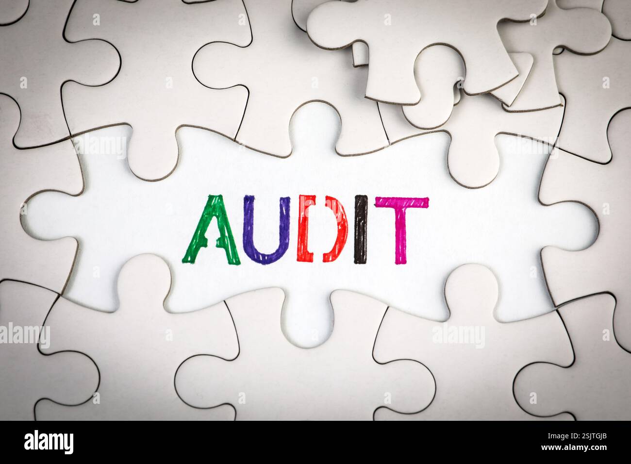 AUDIT Concept. Text on a white page. White puzzle pieces Stock Photo ...