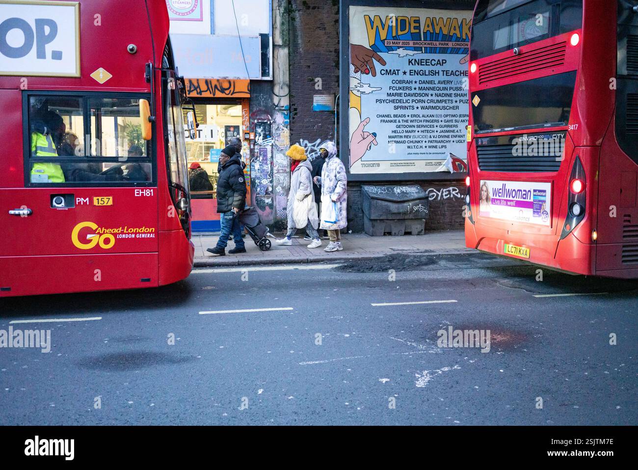 Two red London buses on Peckham Rye with pedestrians Stock Photo - Alamy