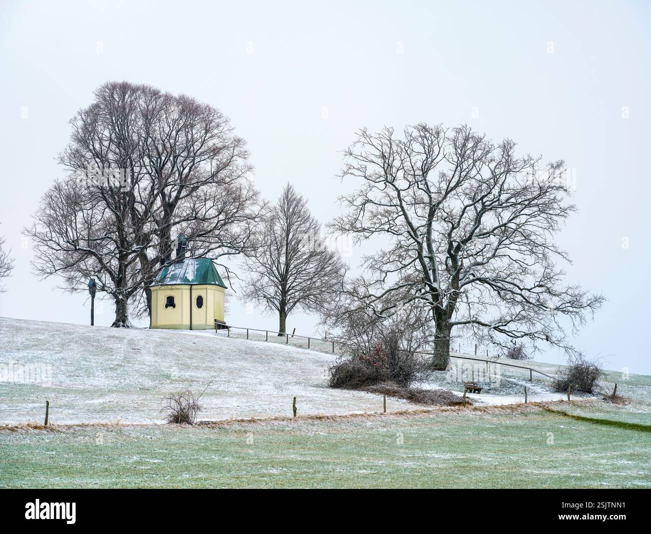 Hill, chapel, trees, cloudy winter afternoon near Degerndorf on the ...