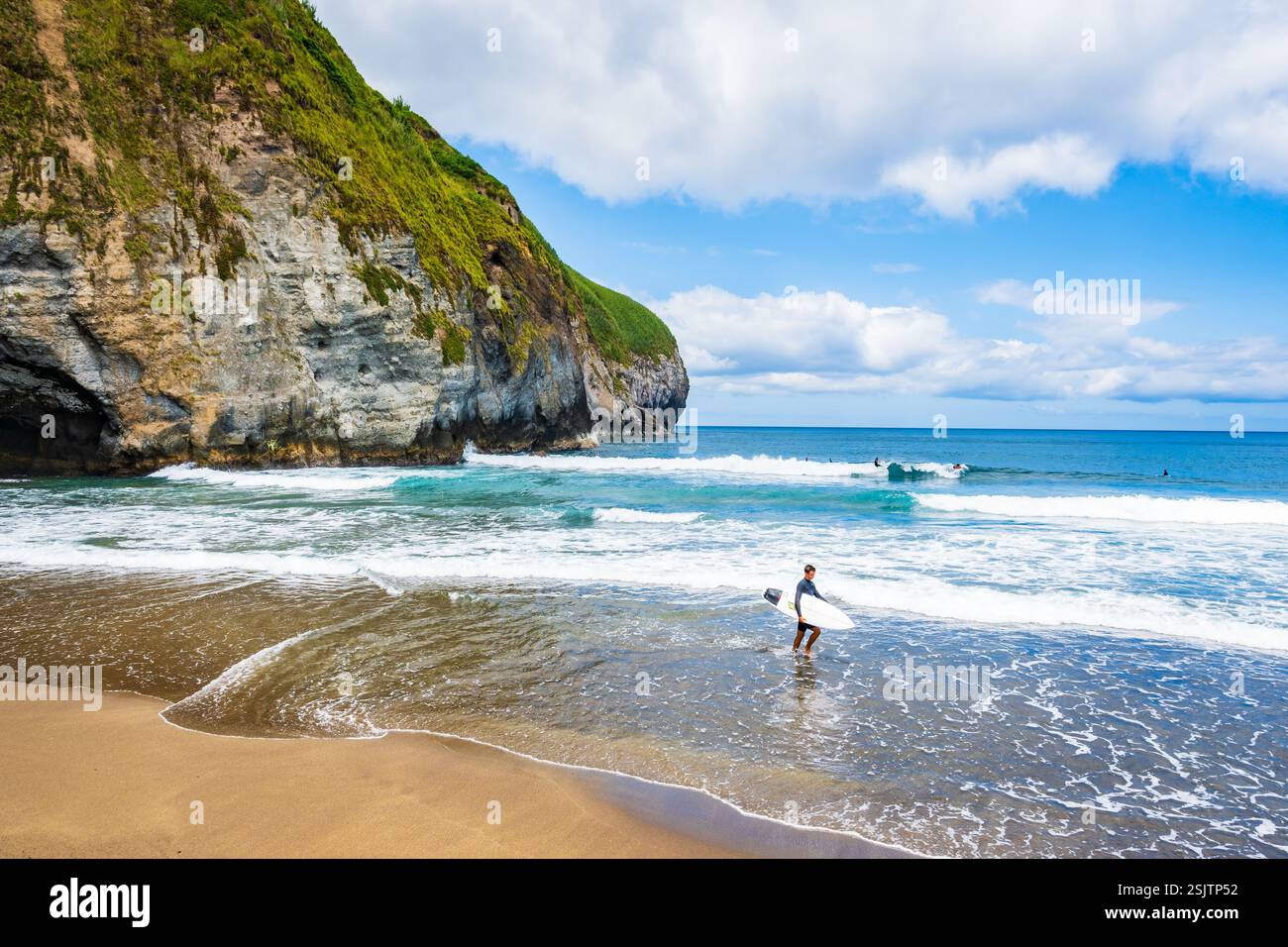 SANTA BARBARA BEACH, SAO MIGUEL ISLAND - JUN 23, 2024: Man with surfing ...