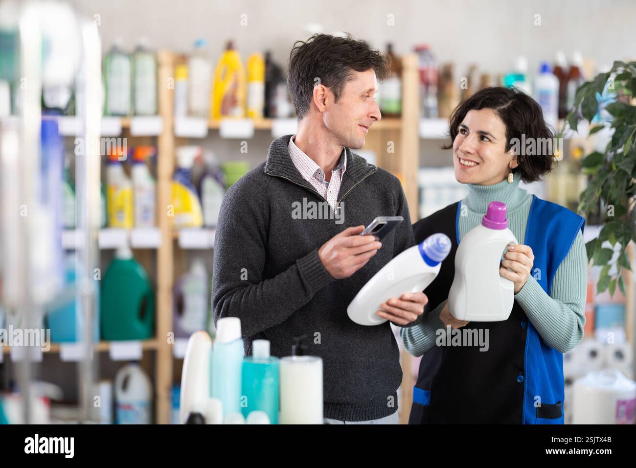 Woman seller help man visitor scan QR code, get information about ...