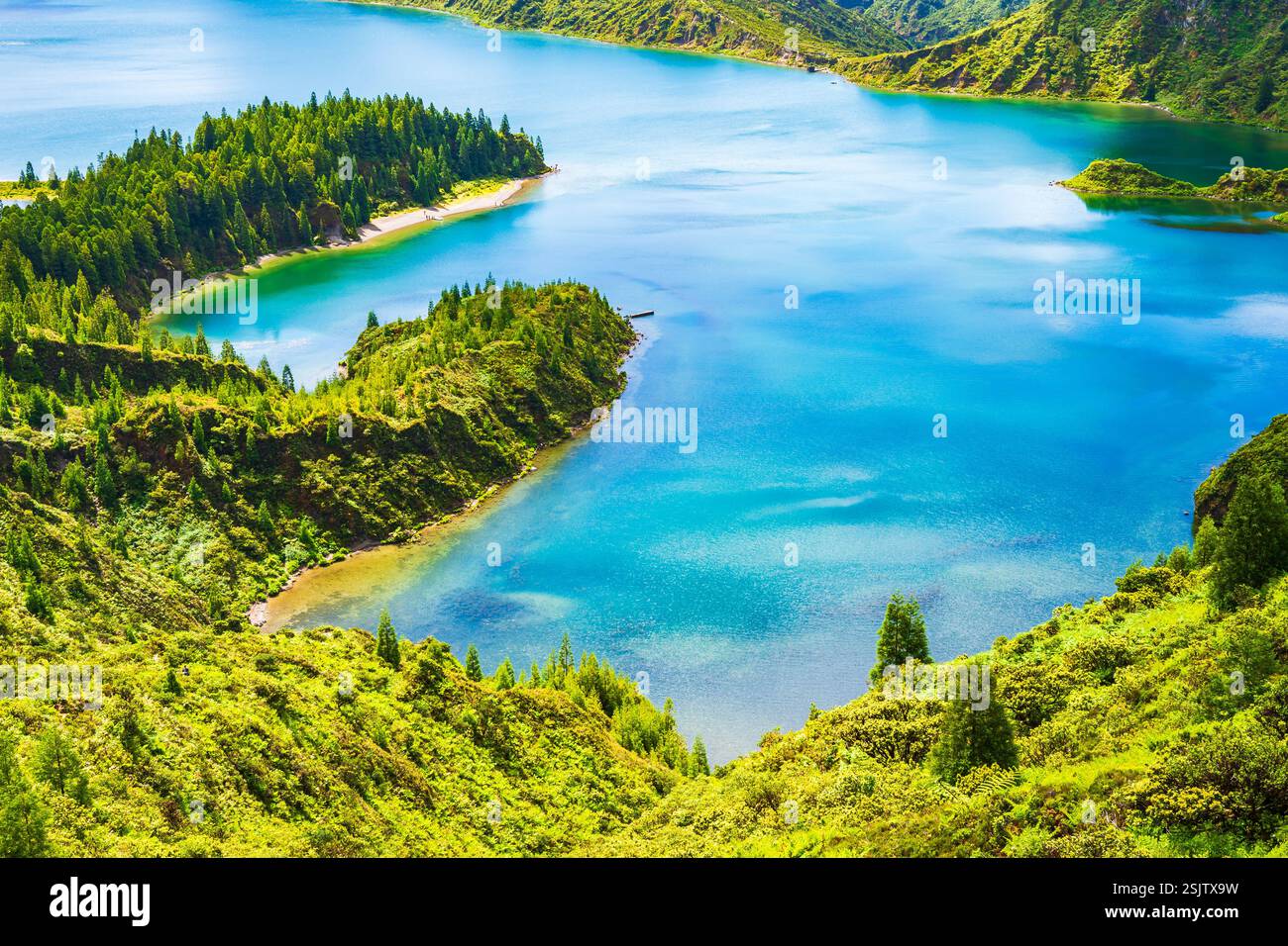 View of Lagoa do Fogo crater lake in green mountain landscape during ...