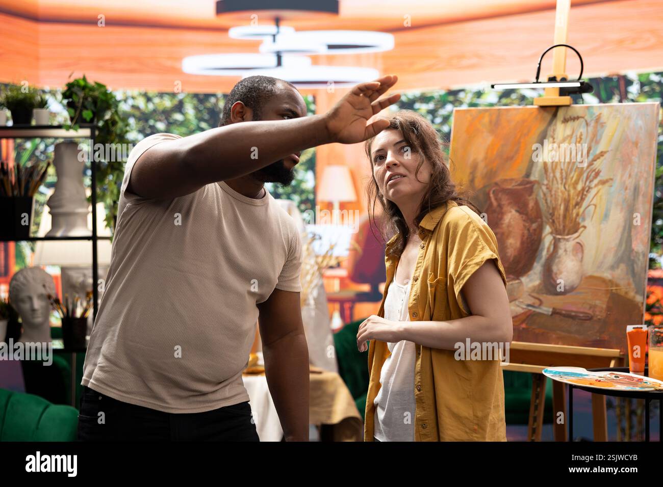 Male painter sharing his vision and ideas before painting a new artwork ...