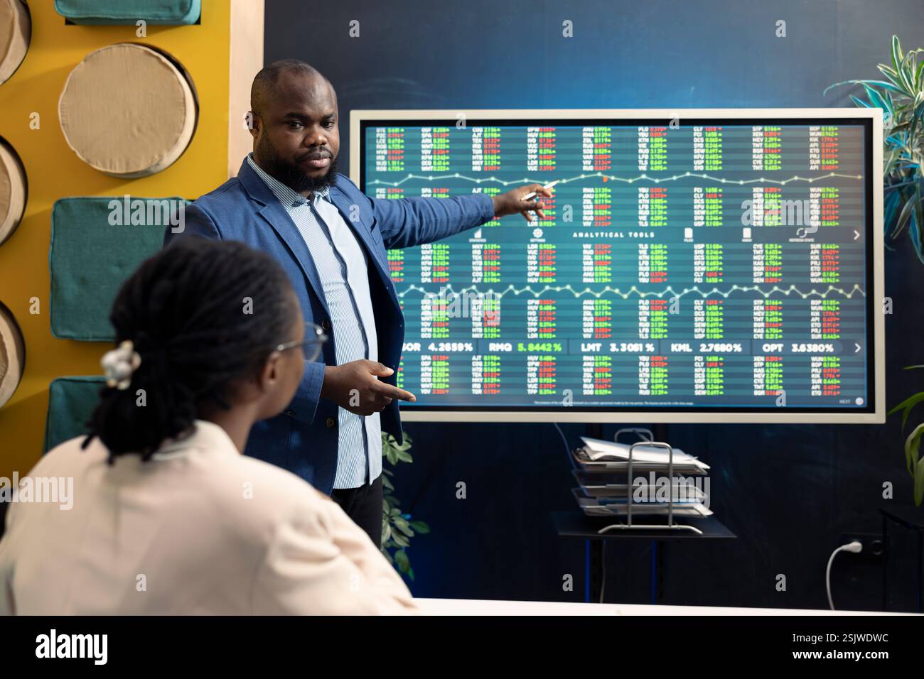 Business analyst making a pitch presentation with annual infographics ...